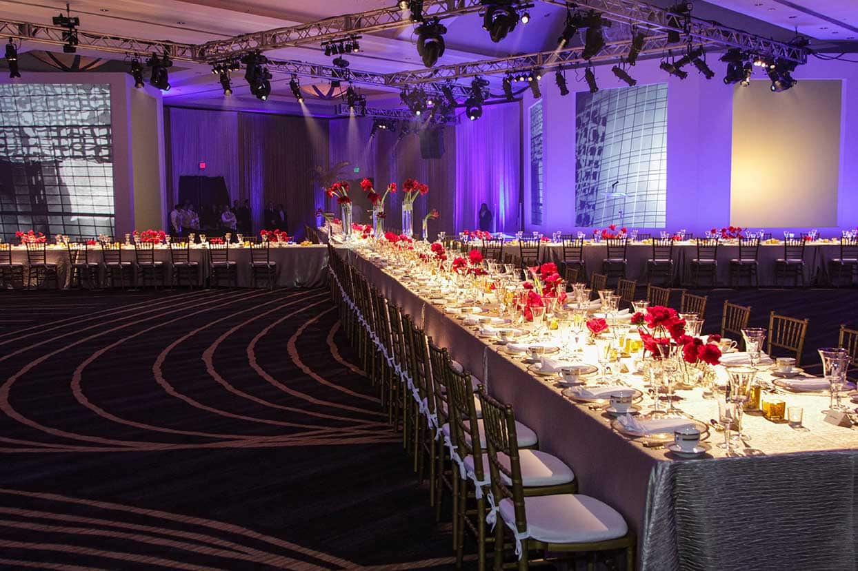 Lighting and decor for corporate dinner event featuring an X table ...